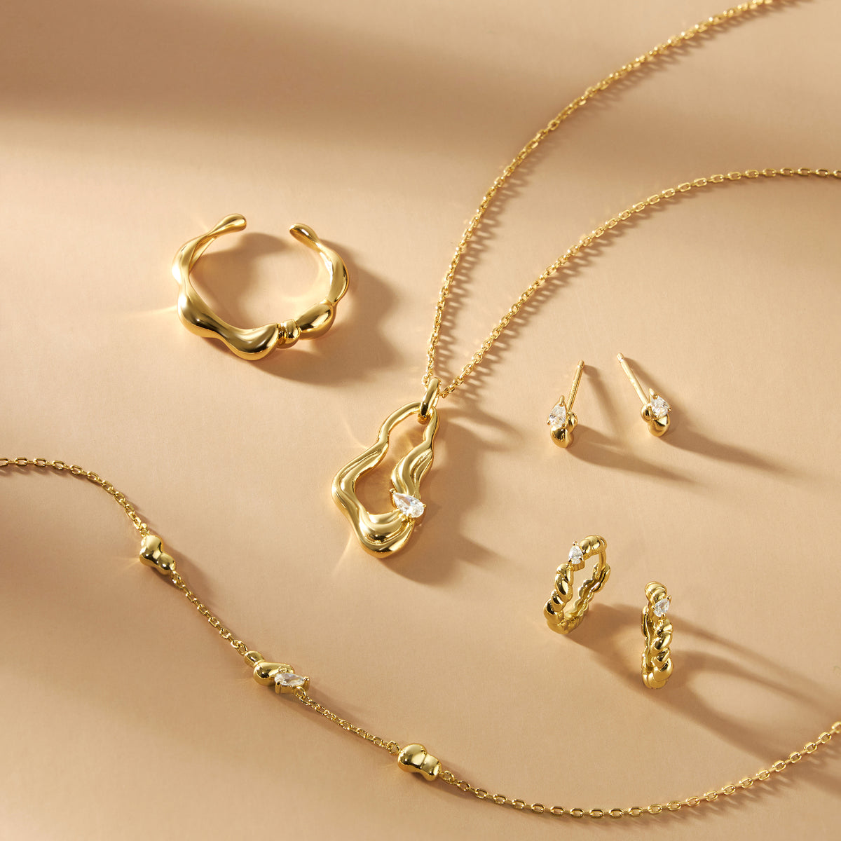 Gold Twisted Wave Huggie Hoop Earrings – Ania Haie EU